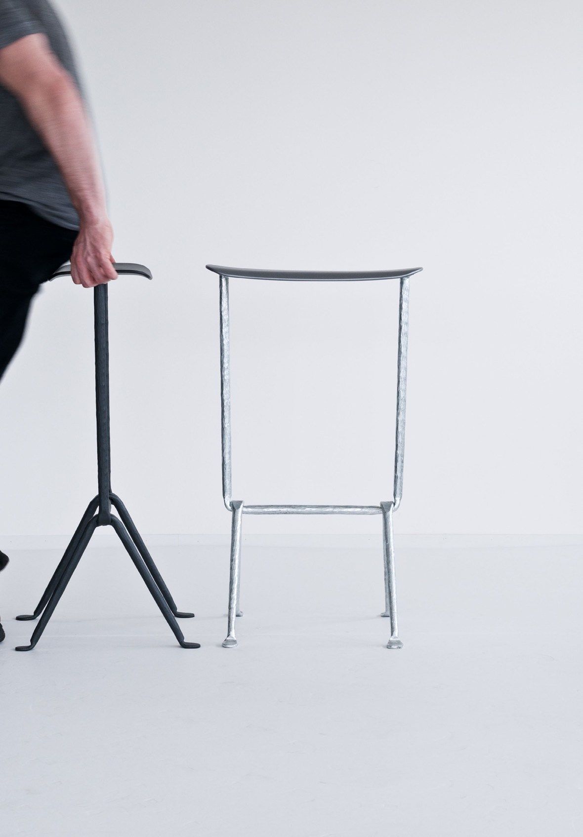 A system of forged iron legs supports surfaces of different sizes and ...