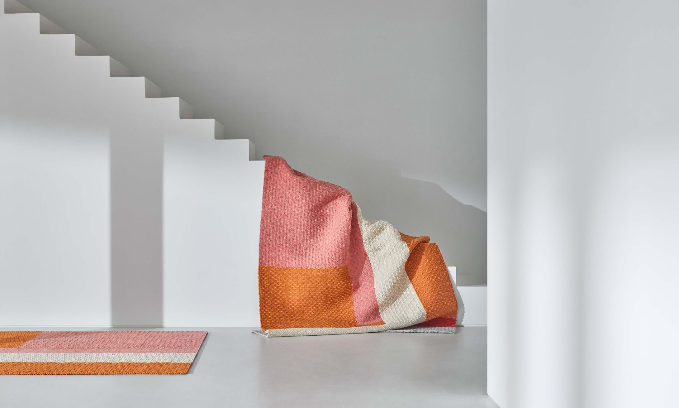 GAN rugs and cushions in natural wool and recycled PET