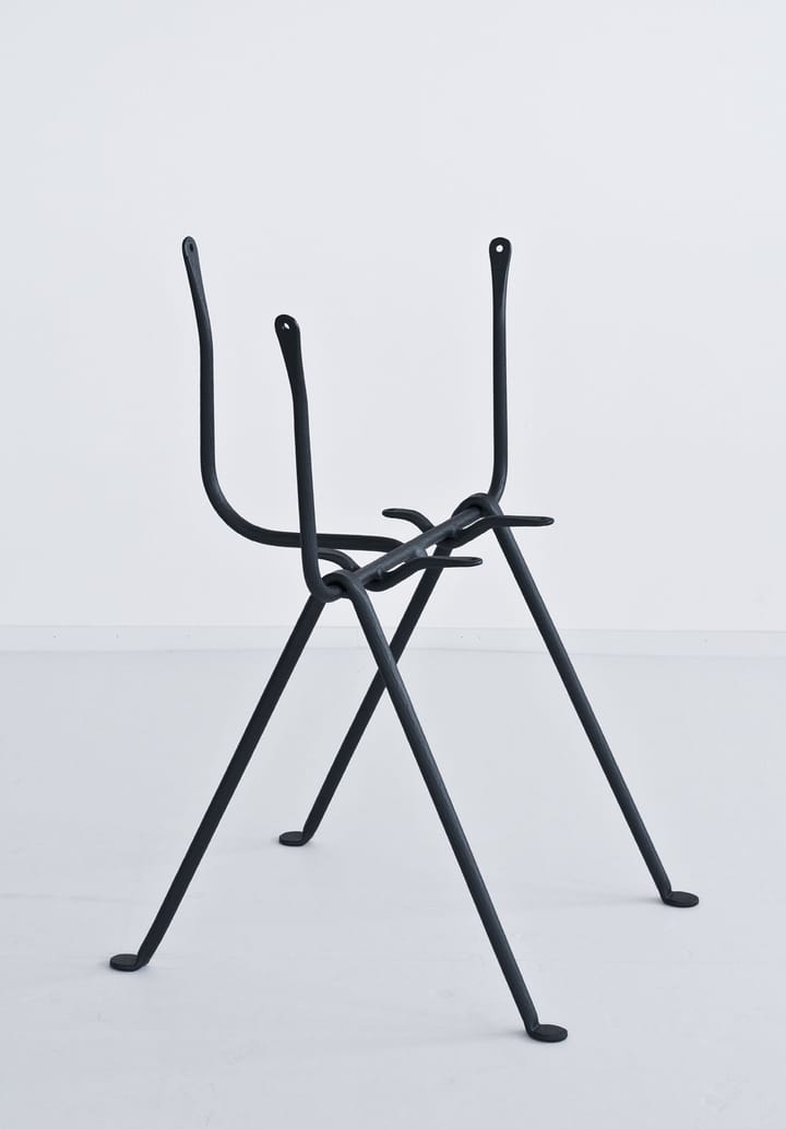 A system of forged iron legs supports surfaces of different sizes and ...