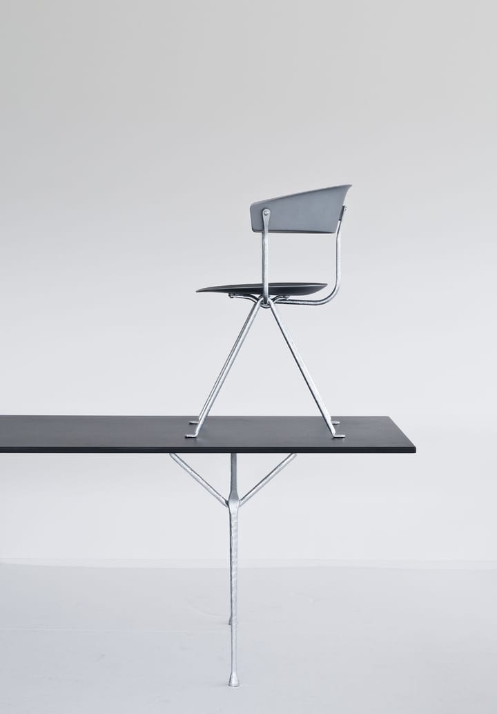 A system of forged iron legs supports surfaces of different sizes and ...