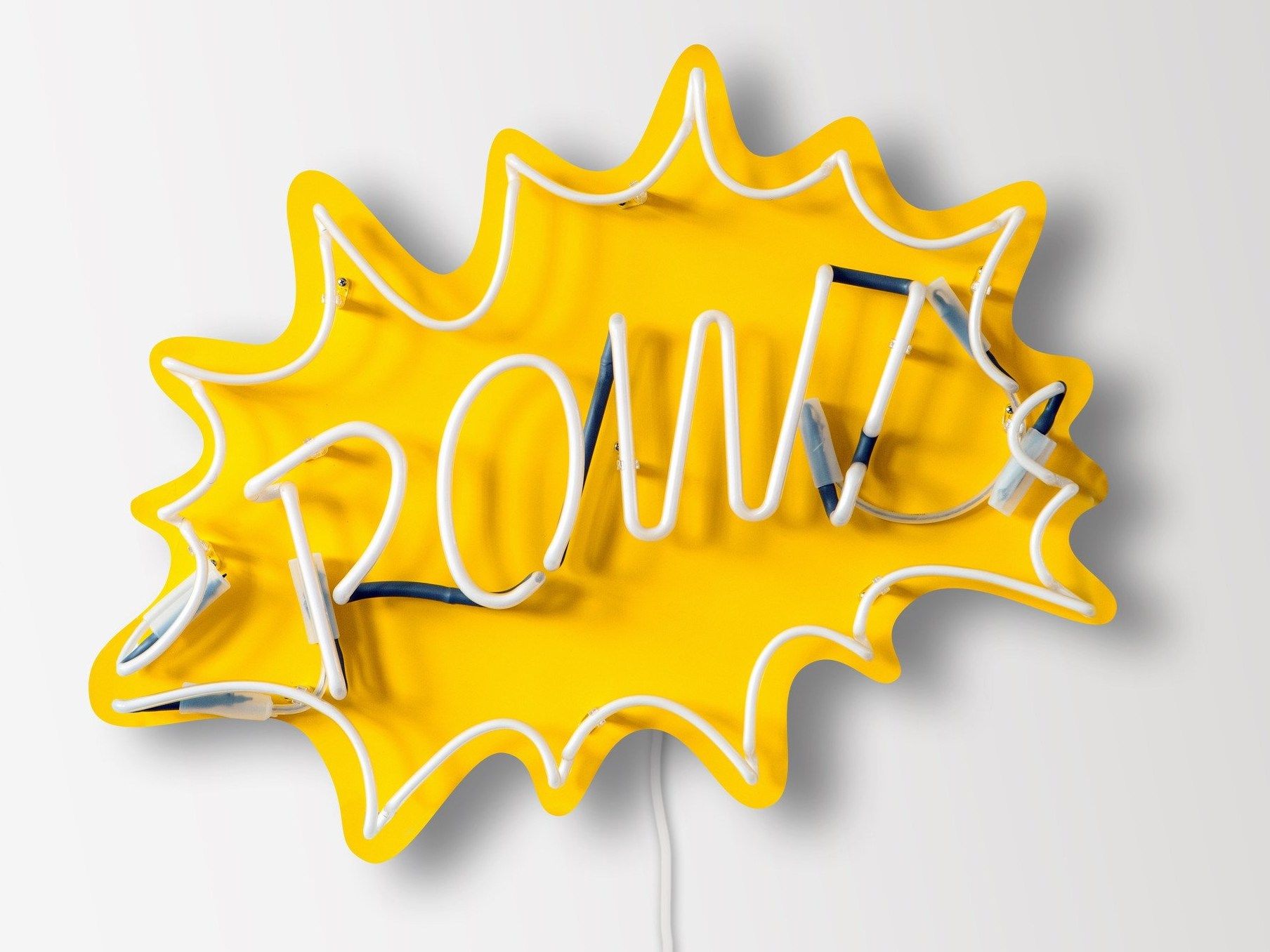 Wall-mounted neon light installation POW By sygns